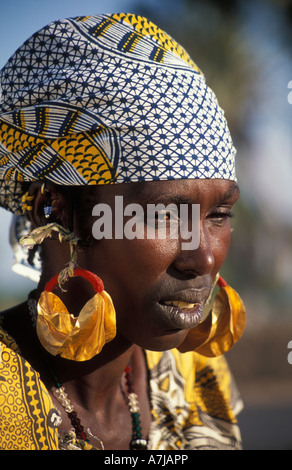 Fula (Peul) woman wearing traditional Fulani golden earrings and a nose ...