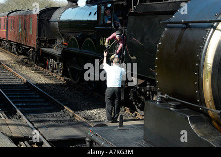 The signalman and steam train driver exchange single line tokens on the ...