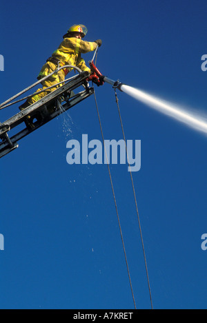 Fireman sprays water on fire in burning garage of house danger risk ...