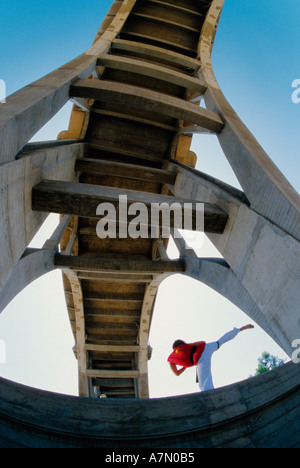 a man practicing karate under a bridge Stock Photo - Alamy