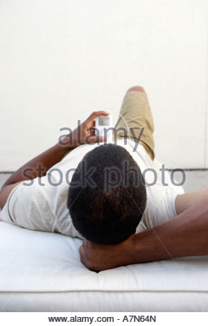 Studio image of young man lying on his back Stock Photo: 6060886 - Alamy