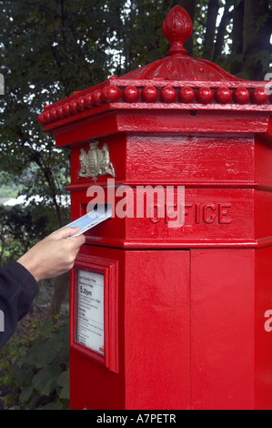 Man posting a letter in Victorian post box Stock Photo - Alamy
