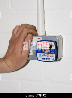 neon light mains tester plugged into a 13 amp socket to check that it ...