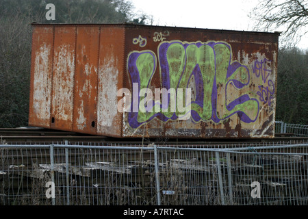 Graffiti on the side of a rusty old fuel tank Stock Photo - Alamy