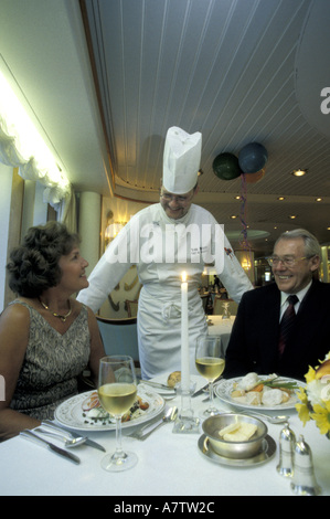 Cruise ship dining room chef preparing food for cruise ship passengers ...