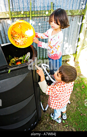 Girl In Kitchen Making Compost Scraping Vegetable Leftovers Into Bin ...