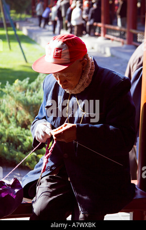 An older Chinese man selling traditional herbal medicines by a trail in ...