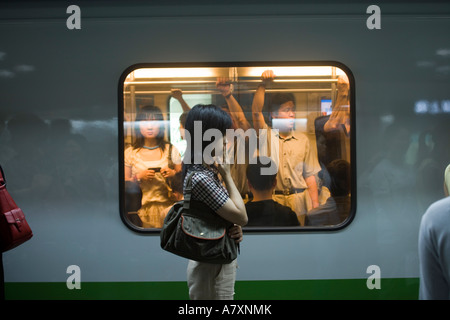 Asia China Shanghai Passenger waits for crowded Metro subway train ...