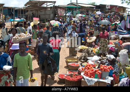 Traditional West African open air food market with market traders ...