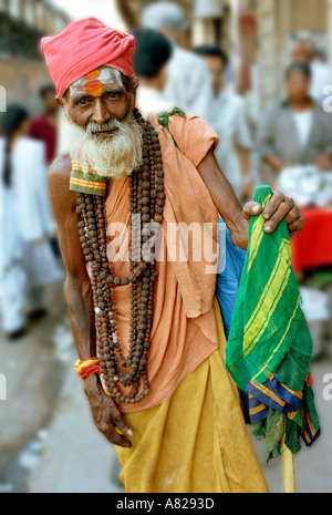 A Sadhu, or Hindu holy man, walks back after taking a bath in River ...