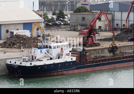 Cargo ship being loaded with scrap metal by grab cranes, Granville ...