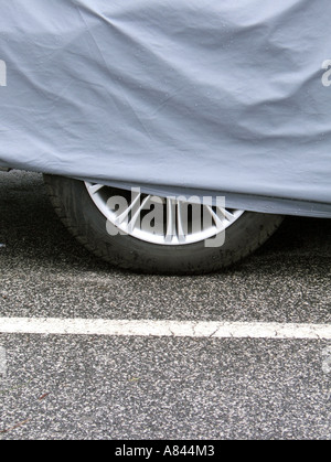 car covered with grey tarpaulin sheet Stock Photo - Alamy