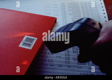 Hand holding bar code scanner and package bag isolated. Barcode scan ...