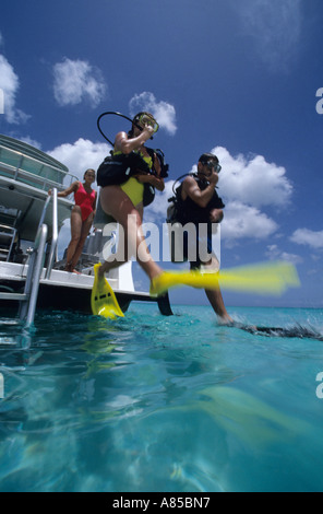 Scuba divers doing giant stride entry off dive boat Grace Bay ...