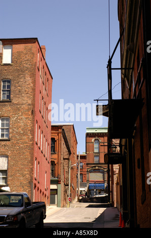 Back alley with fire escape and old mattresses Stock Photo - Alamy
