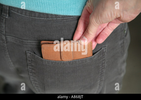 Thief taking money - A pickpocket taking money from a girl's back ...