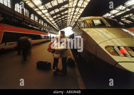 Sad couple hugging saying goodbye before train travel Stock Photo - Alamy