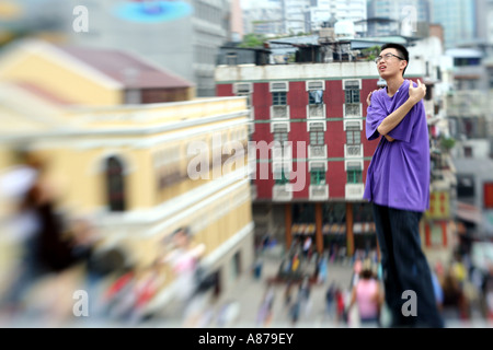 A Chinese teenager looking confused at Cathedral Square, Macau Stock ...