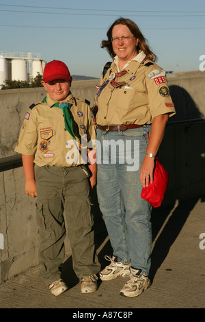 Two Boy Scouts in uniform are pictured giving the three-finger Scout ...