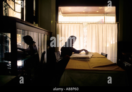 A bussiness woman has a quick coffee running errands and working from ...