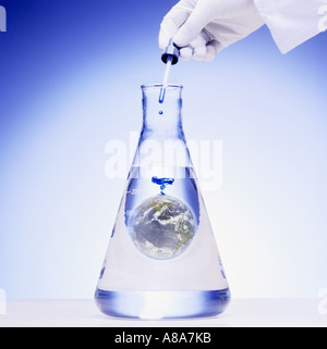 Scientist adding chemical to the world Stock Photo - Alamy