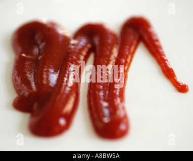 Squiggle of tomato ketchup squeezed out of squeezy bottle on white ...