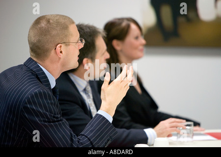 Businessmen posing for a commercial photoshoot in office boardroom ...