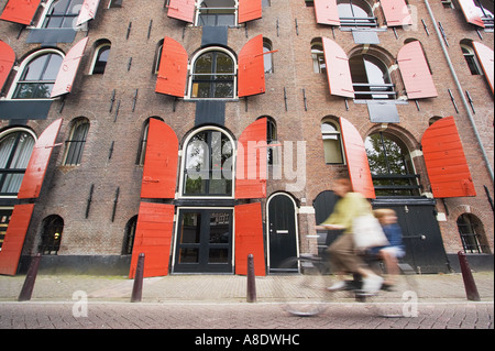 Cyclist Passing Shuttered Building Stock Photo - Alamy