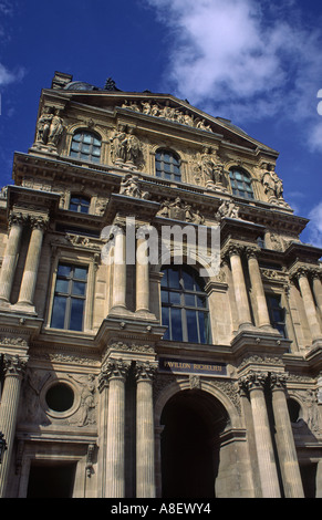 Low-angle view of Louvre Palace against clear blue sky seen through ...