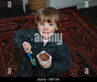 Little Girl Eating A Chocolate Pudding Stock Photo - Alamy