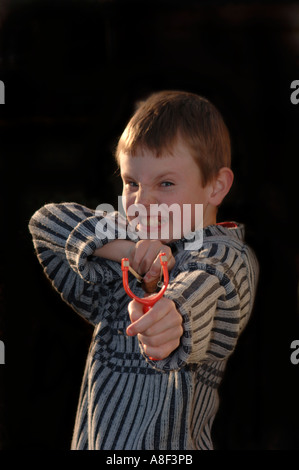 A boy with a catapult Stock Photo - Alamy