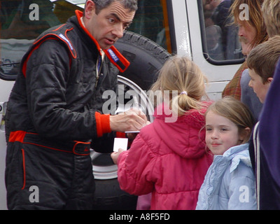 Rowan Atkinson signing autographs at a motor racing circuit England GB ...