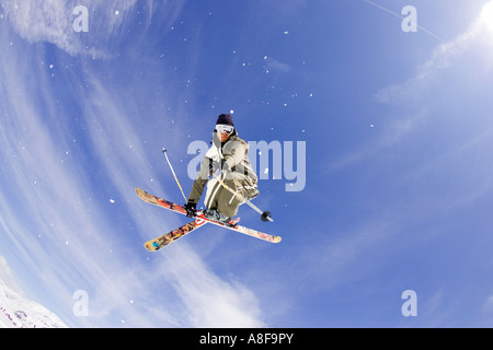 Skier crossed up over jump Stock Photo - Alamy
