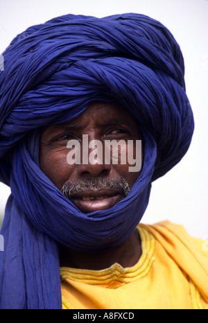 Tuareg man in traditional indigo dress selling salt blocks, Timbuktu ...