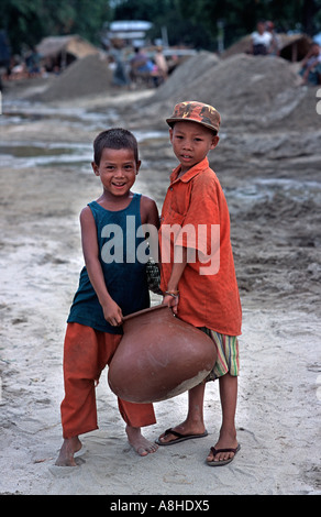 Boy carrying water pot Stock Photo - Alamy