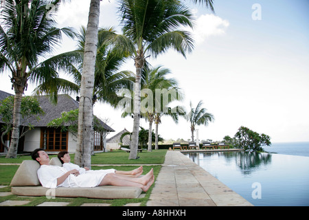 Young woman lying besides a swimming pool Stock Photo - Alamy