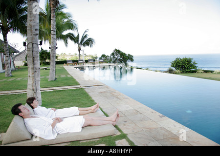 Young woman lying besides a swimming pool Stock Photo - Alamy