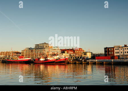 Old fishing harbour Scheveningen at the coast of Holland with sunset ...