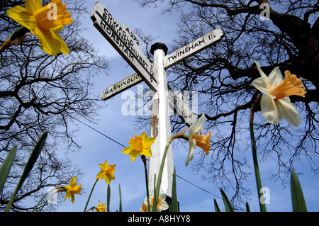 Old wooden road sign showing direction, destination and distance to ...