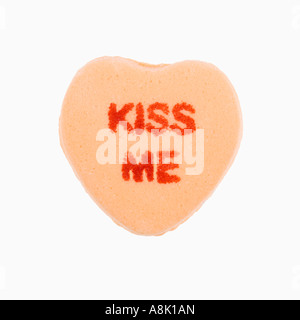 Orange candy heart that reads kiss me against white background Stock ...
