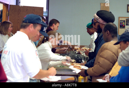 Homeless men in a soup kitchen, a nun helping the charity is run by the ...