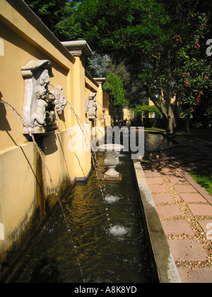 House with a fountain in a beautiful garden near the forest, in early ...