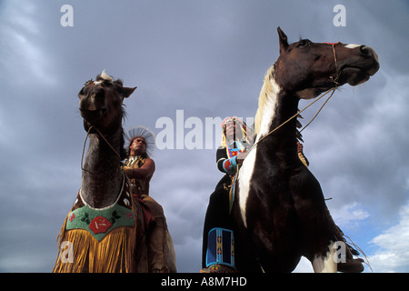 A Native American Indian man riding bareback on a horse in the prairie ...