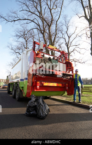 bin lorry / refuse collection. Image shows bin man loading a refuse ...
