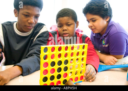 Kids playing Connect Four vertical checker game. After School Study ...