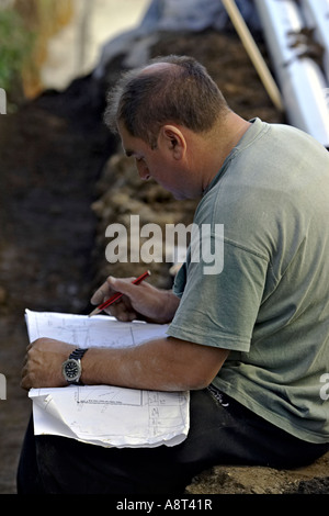 The construction foreman supervisor reviewing drawings Stock Photo - Alamy