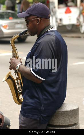 Black jazz performer plays the saxophone on the stage with spotlights ...