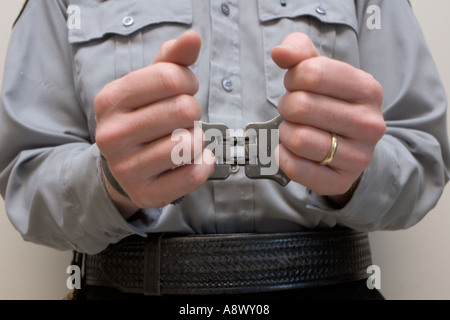 Correctional officer in handcuffs and in uniform Stock Photo - Alamy
