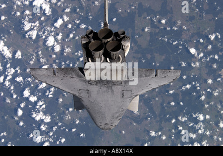 Aerial view of Space Shuttle Discovery over Earth as it approaches the ...