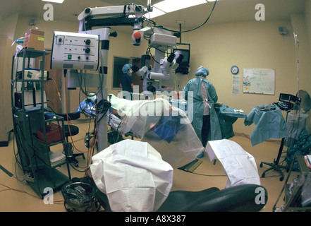 Nurses prepare operating room and electronic overhead operating ...